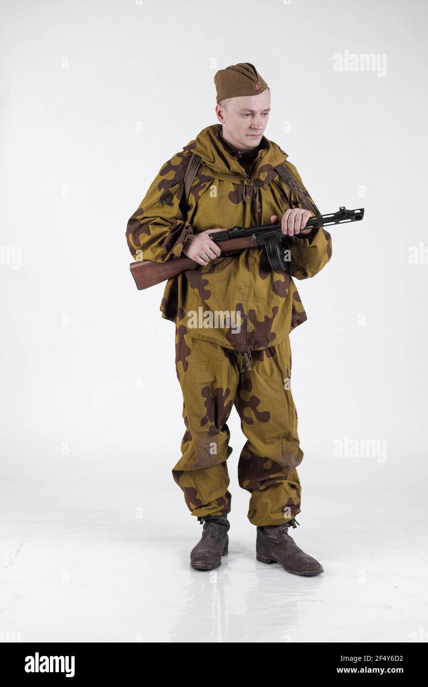 Actor man in an old military uniform and camouflage sniper marksman ...