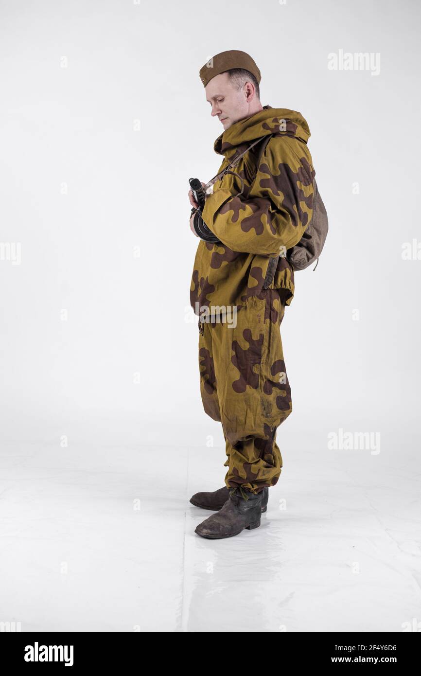 Actor man in an old military uniform and camouflage sniper marksman ...