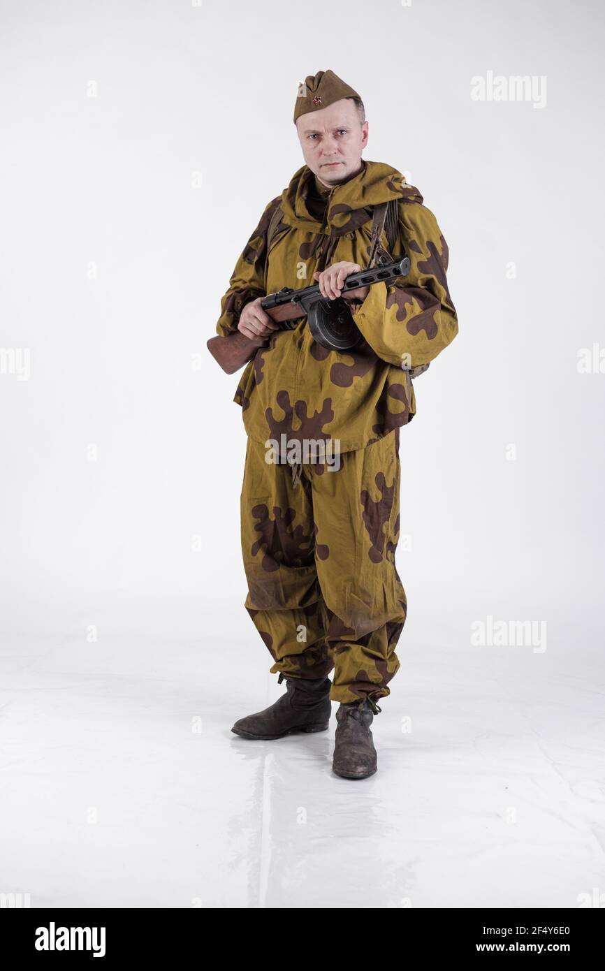 Actor man in an old military uniform and camouflage sniper marksman ...