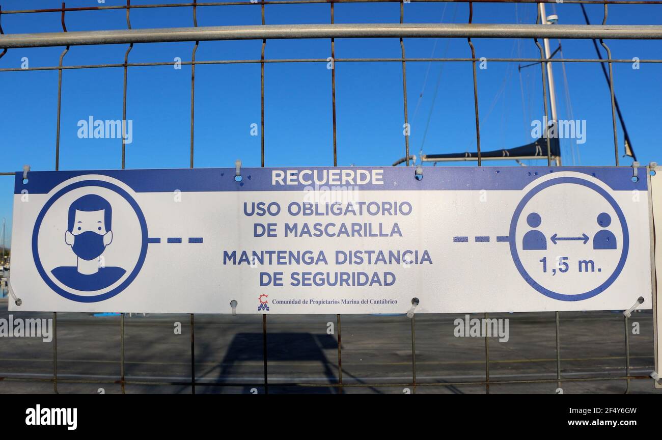 White and blue warning sign to obey rules wear a face mask and keep ...