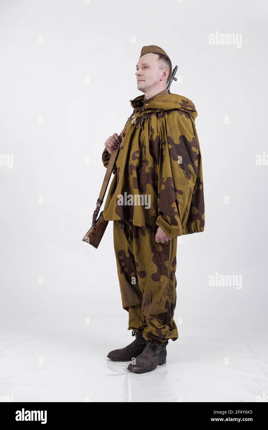 Actor man in an old military uniform and camouflage sniper marksman ...
