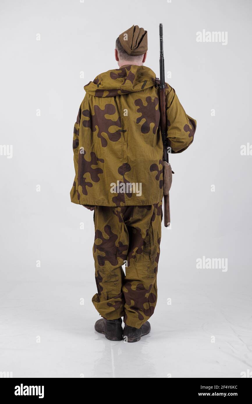 Actor man in an old military uniform and camouflage sniper marksman ...