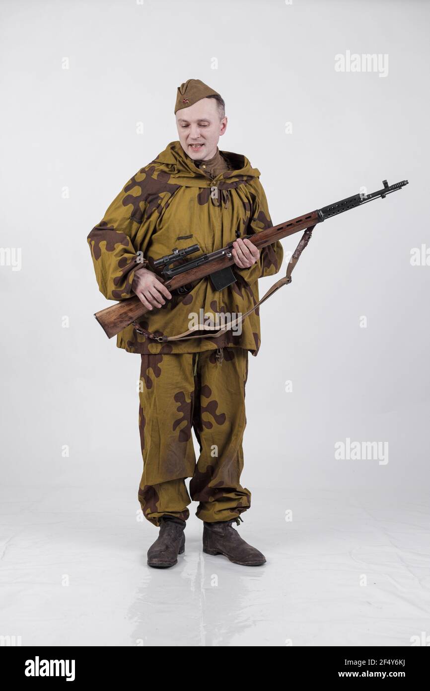 Actor man in an old military uniform and camouflage sniper marksman ...