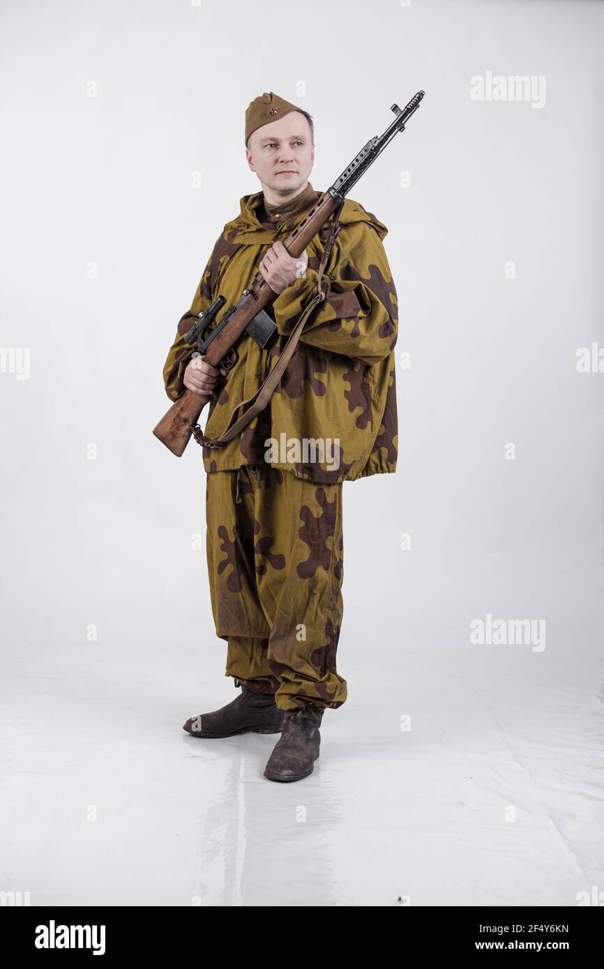 Actor man in an old military uniform and camouflage sniper marksman ...