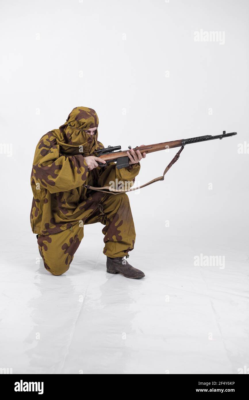 Actor man in an old military uniform and camouflage sniper marksman ...