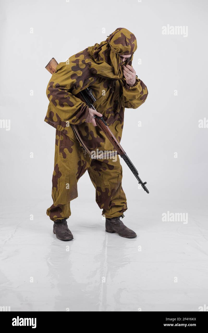 Actor man in an old military uniform and camouflage sniper marksman ...