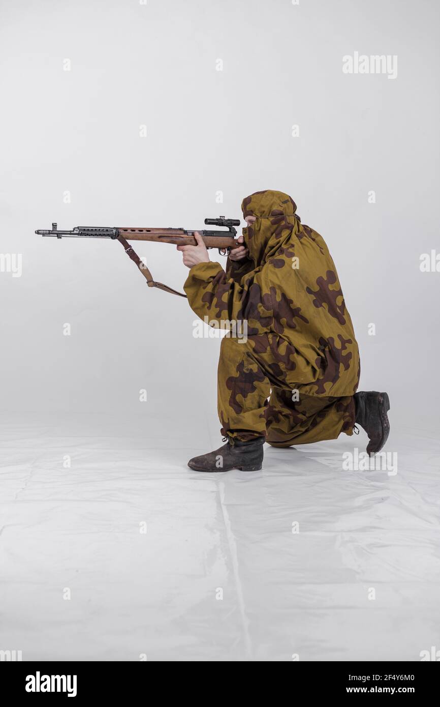 Actor man in an old military uniform and camouflage sniper marksman ...