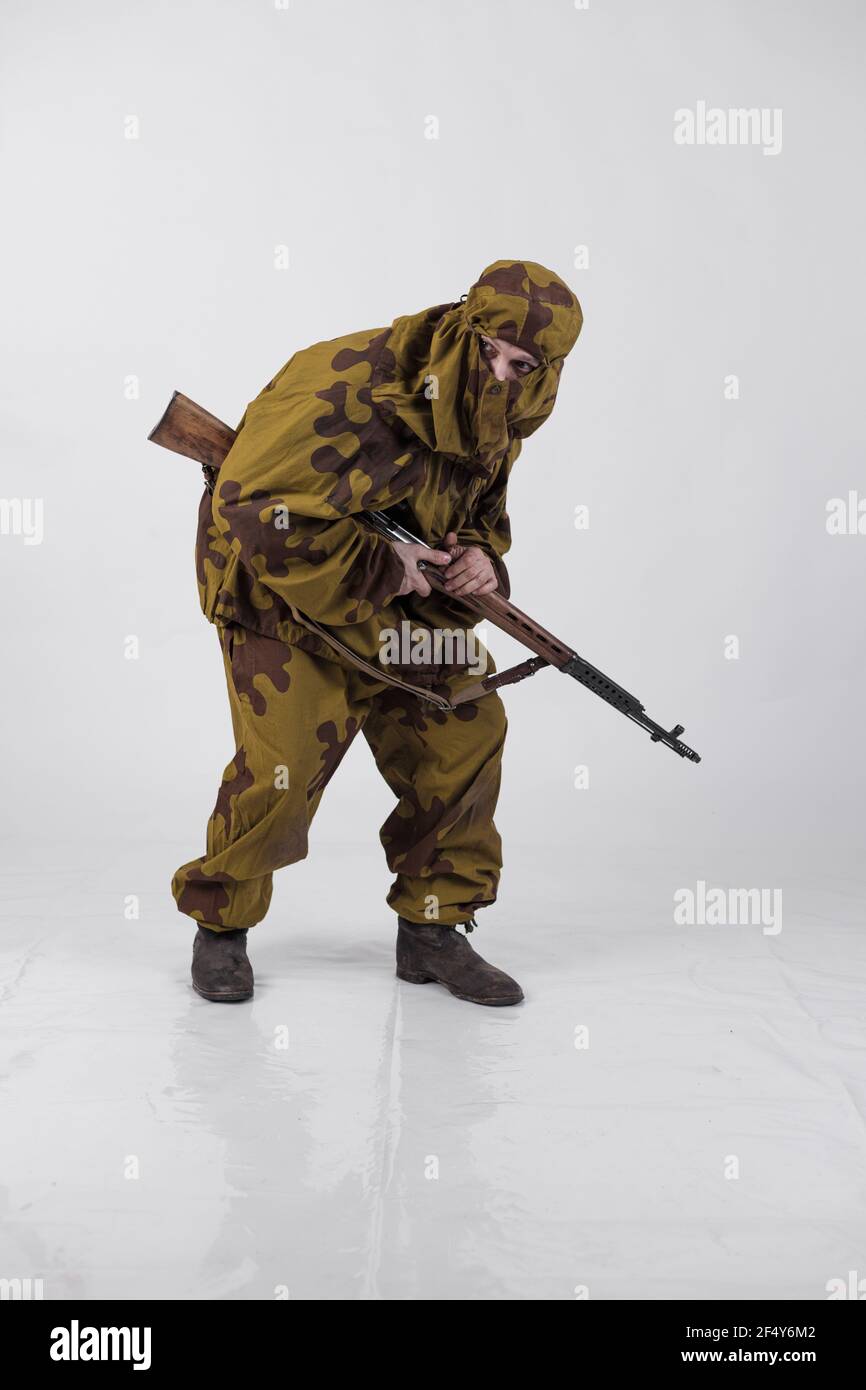 Actor man in an old military uniform and camouflage sniper marksman ...