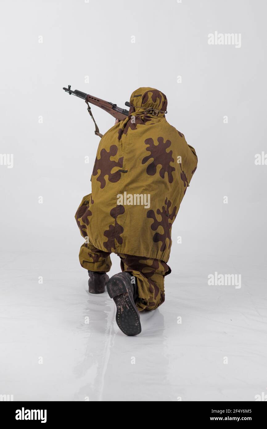 Actor man in an old military uniform and camouflage sniper marksman ...