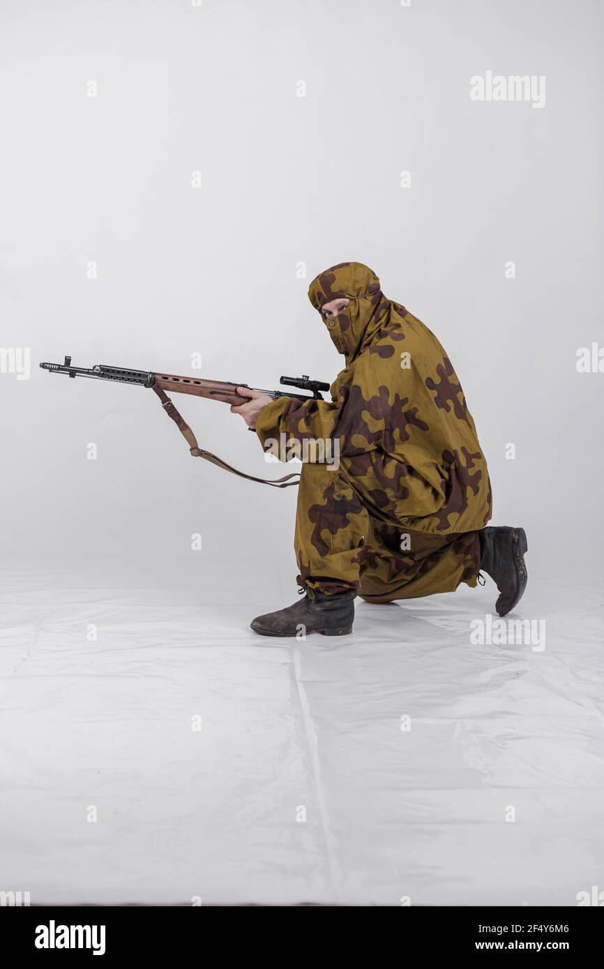 Actor man in an old military uniform and camouflage sniper marksman ...
