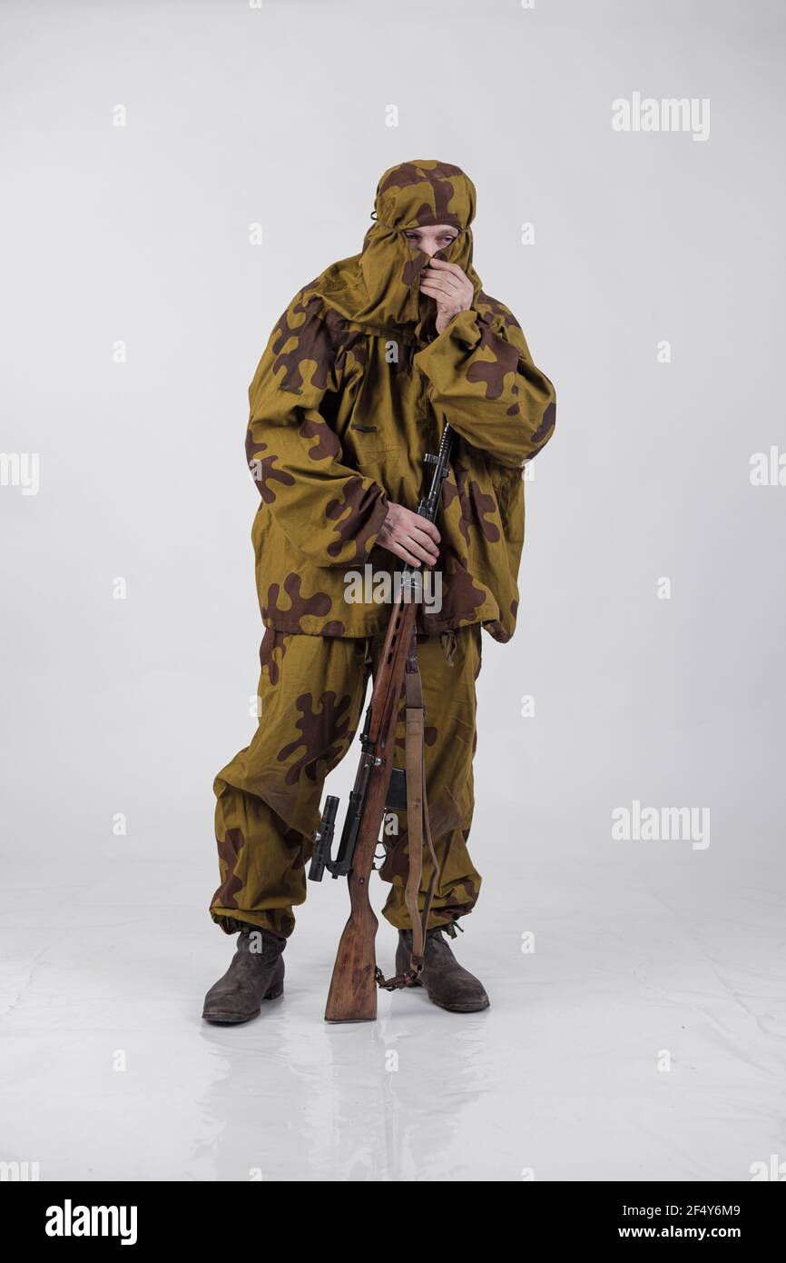 Actor man in an old military uniform and camouflage sniper marksman ...