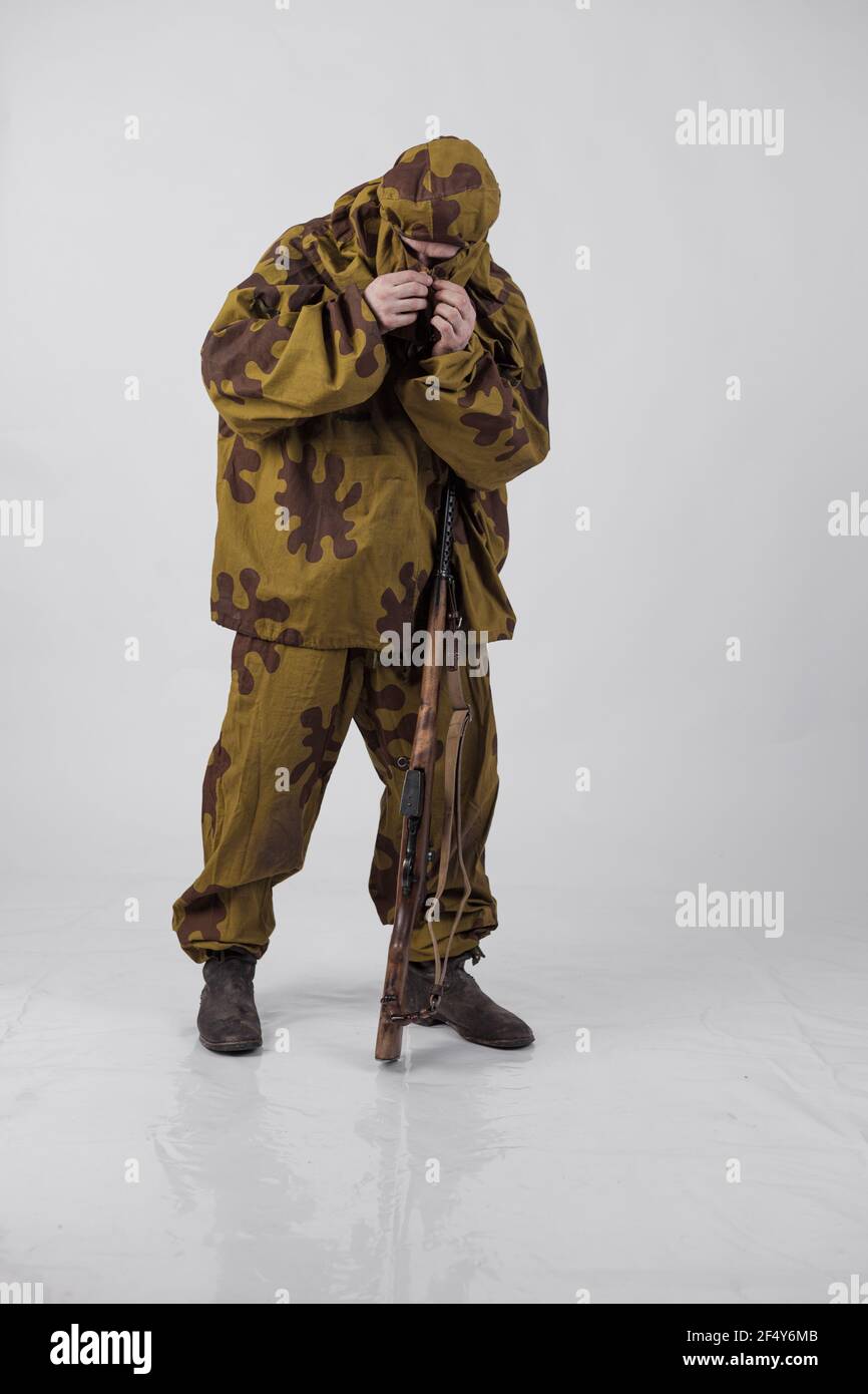 Actor man in an old military uniform and camouflage sniper marksman ...
