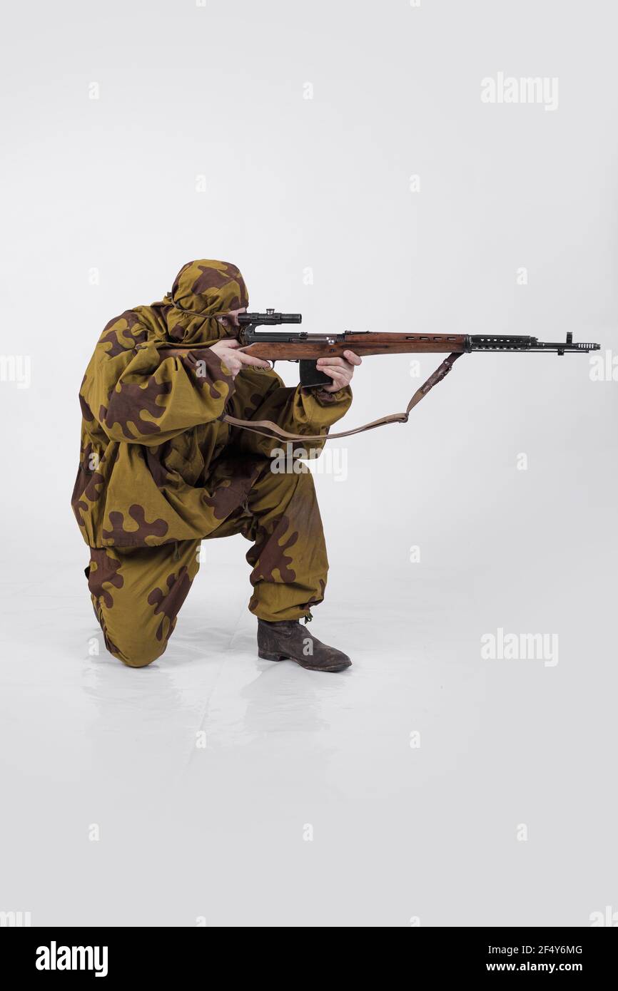 Actor man in an old military uniform and camouflage sniper marksman ...