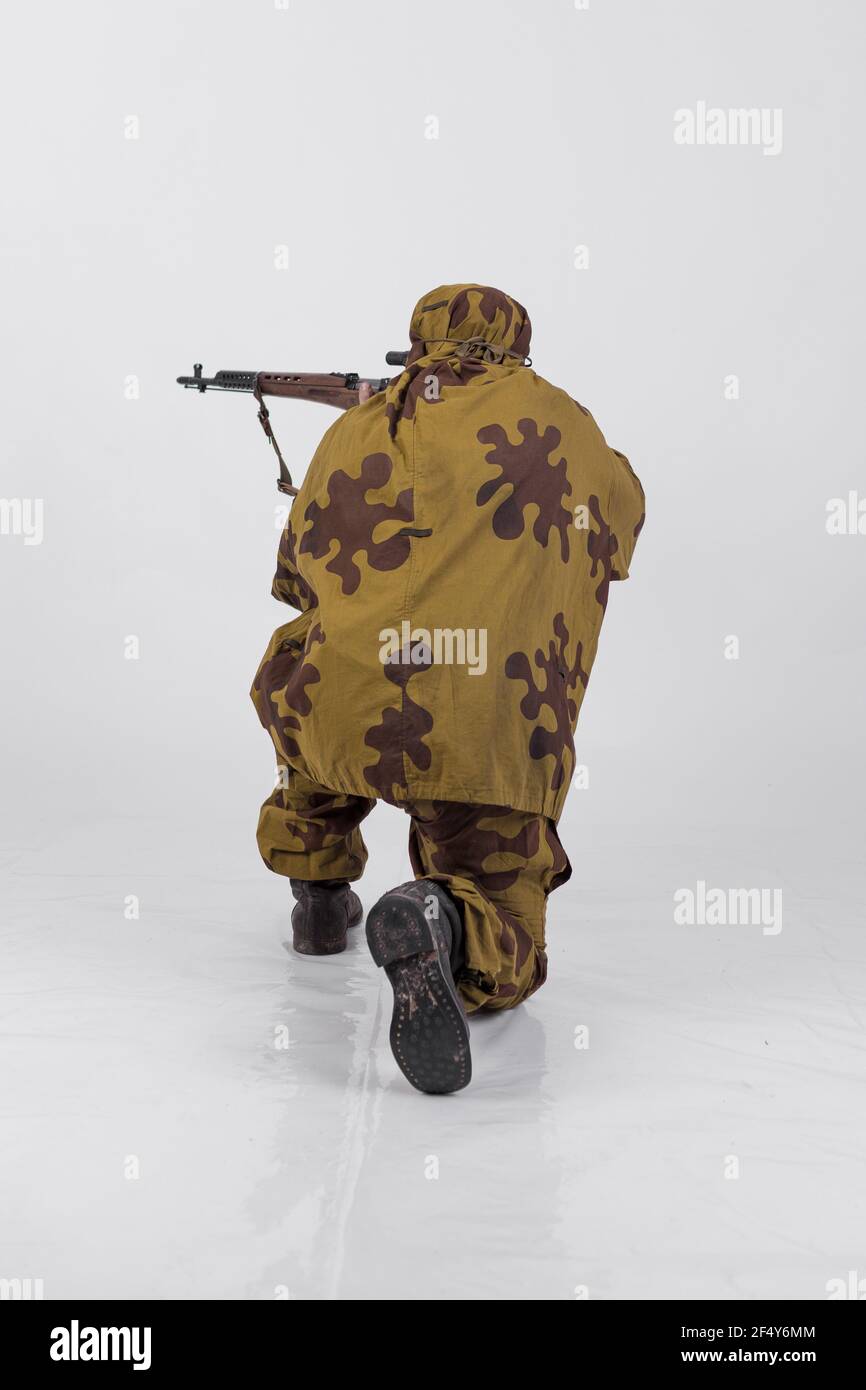 Actor man in an old military uniform and camouflage sniper marksman ...