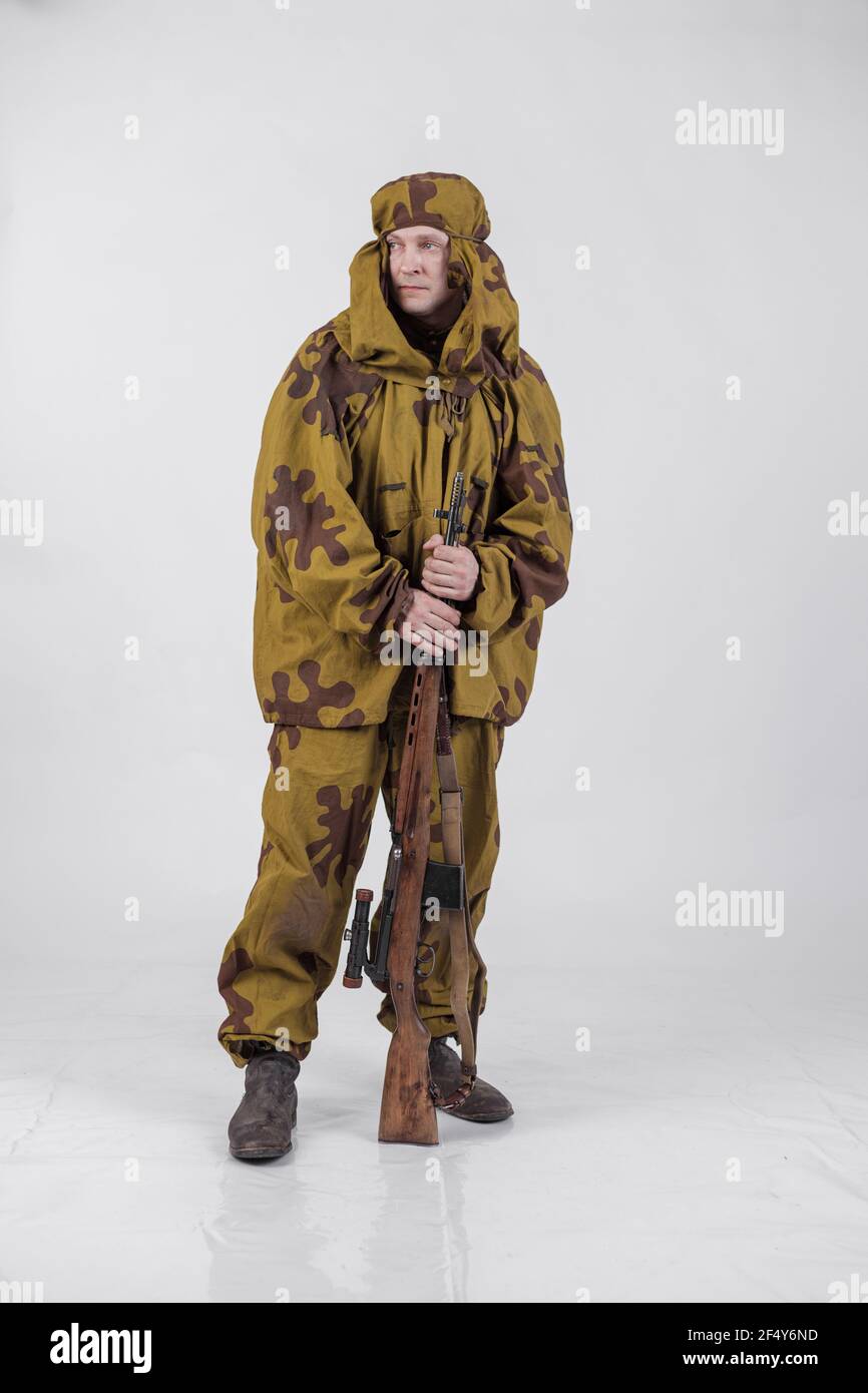 Actor man in an old military uniform and camouflage sniper marksman ...