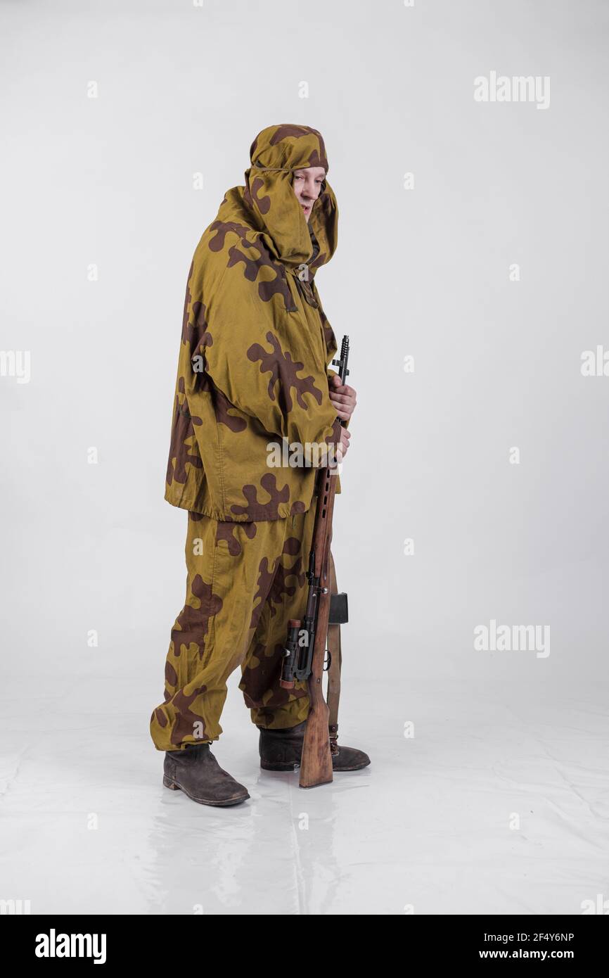 Actor man in an old military uniform and camouflage sniper marksman ...