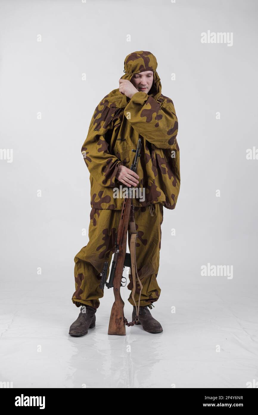 Actor man in an old military uniform and camouflage sniper marksman ...