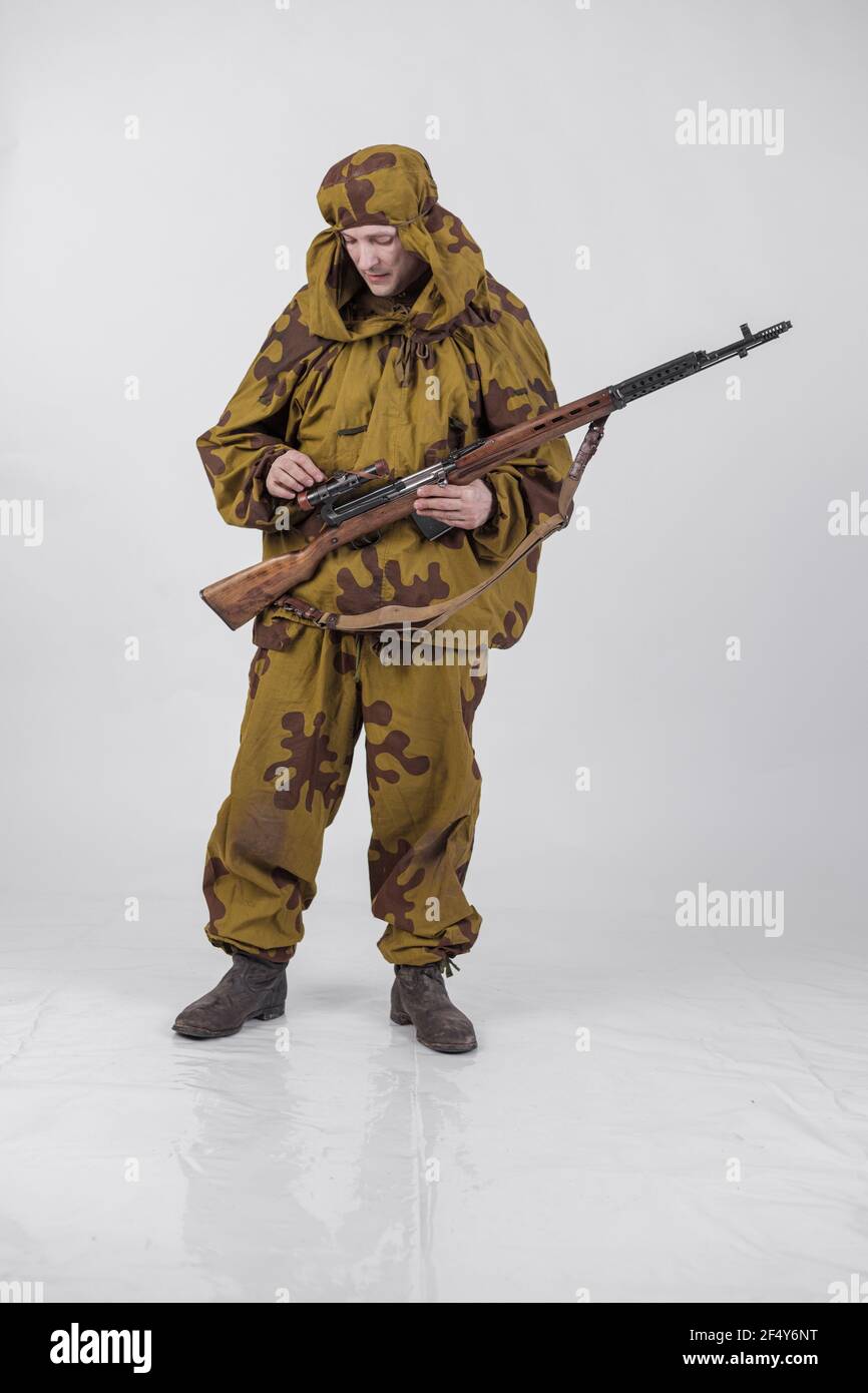 Actor man in an old military uniform and camouflage sniper marksman ...