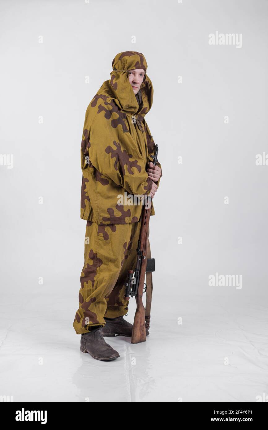 Actor man in an old military uniform and camouflage sniper marksman ...