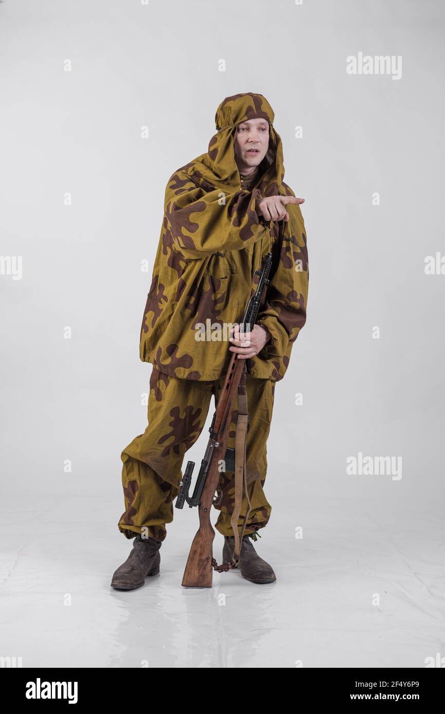 Actor man in an old military uniform and camouflage sniper marksman ...