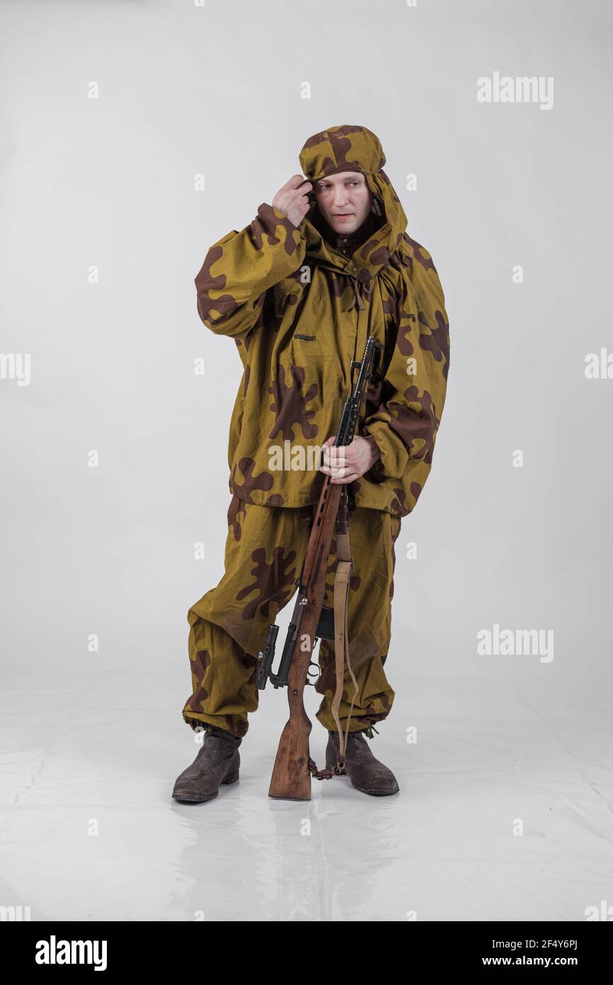Actor man in an old military uniform and camouflage sniper marksman ...