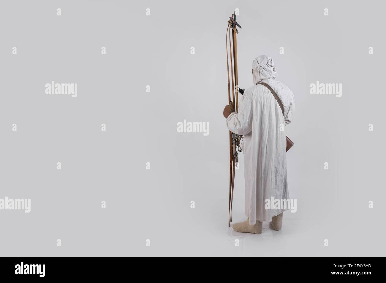 A man in a winter military uniform white camouflage, a soldier of the ...