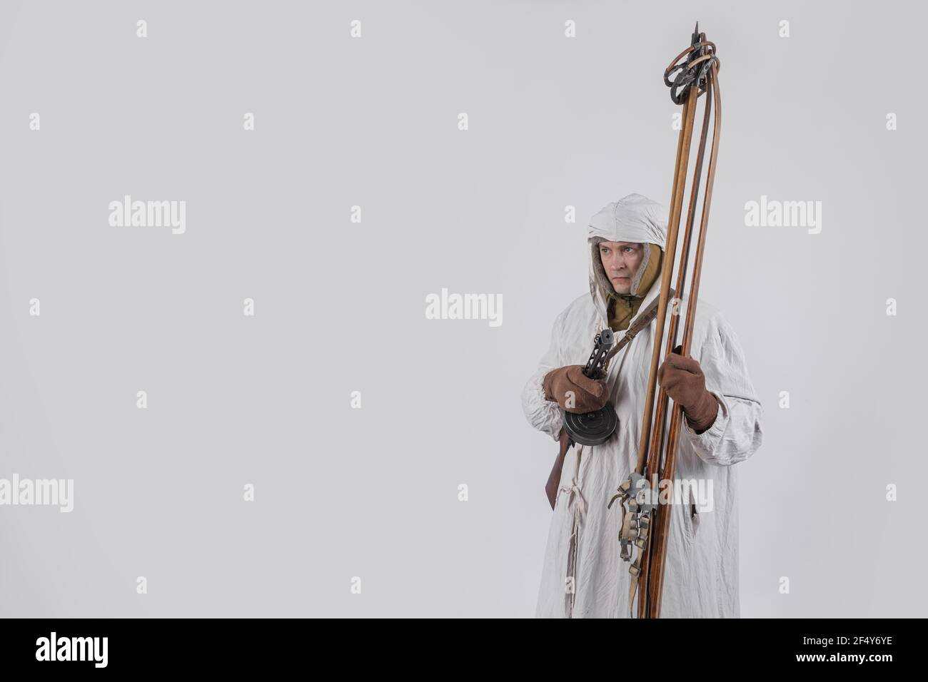 A man in a winter military uniform white camouflage, a soldier of the ...