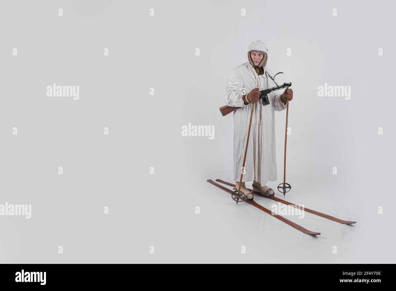 A man in a winter military uniform white camouflage, a soldier of the ...