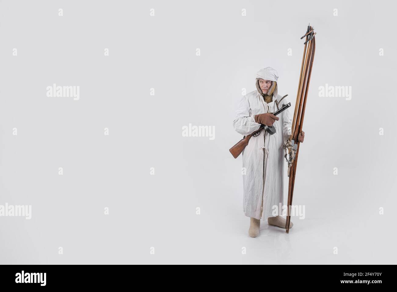 A man in a winter military uniform white camouflage, a soldier of the ...