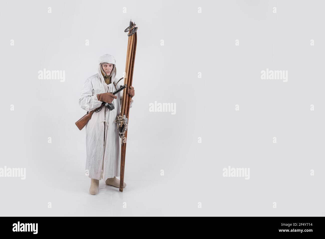 A man in a winter military uniform white camouflage, a soldier of the ...