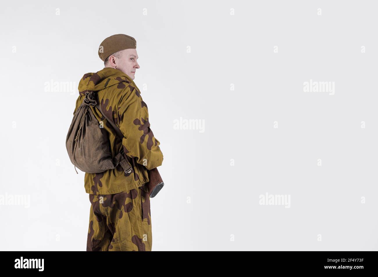 Actor man in an old military uniform and camouflage sniper marksman ...