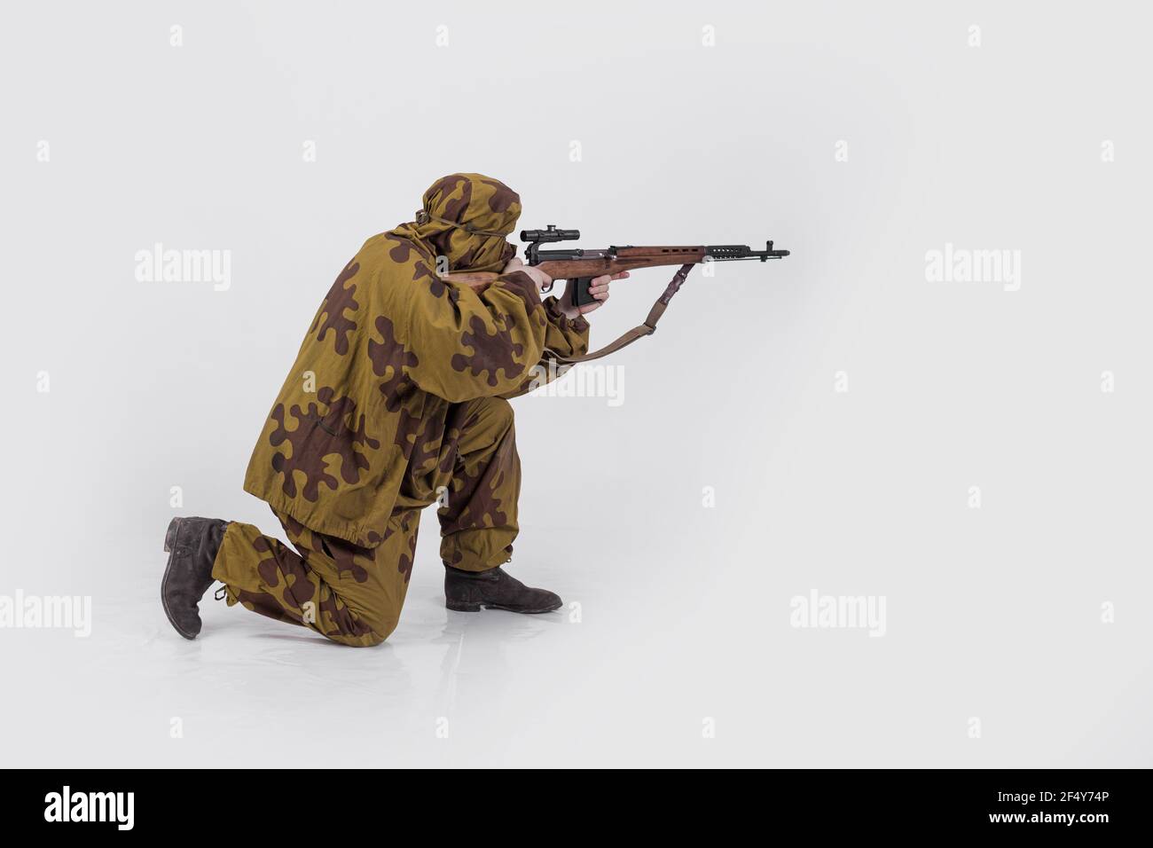 Actor man in an old military uniform and camouflage sniper marksman ...