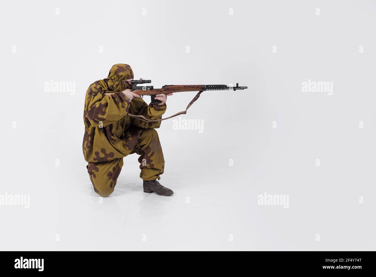 Actor man in an old military uniform and camouflage sniper marksman ...