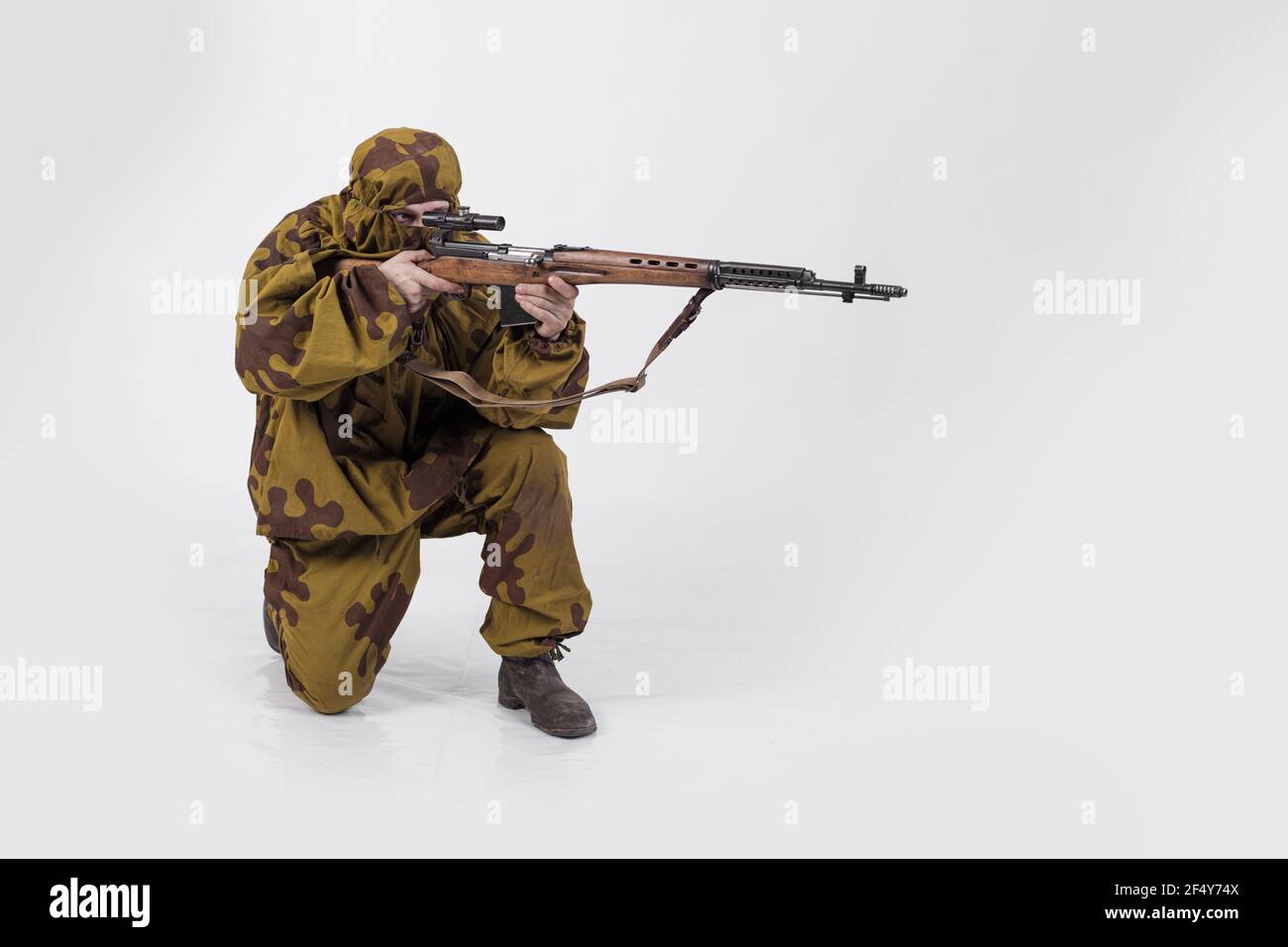 Actor man in an old military uniform and camouflage sniper marksman ...