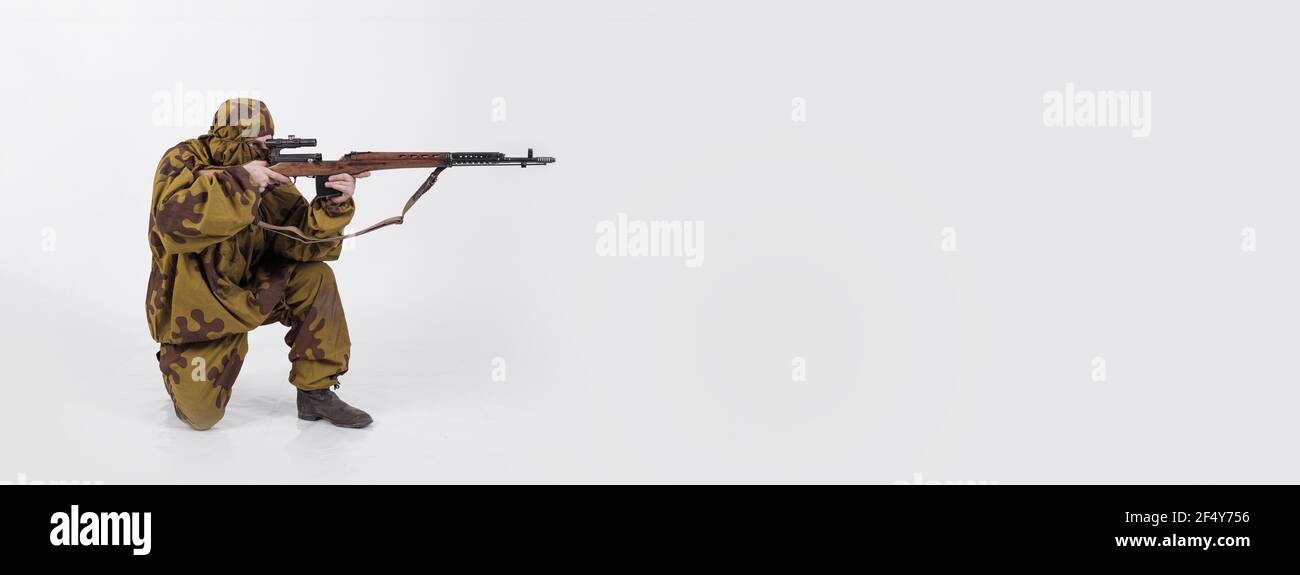 Actor man in an old military uniform and camouflage sniper marksman ...
