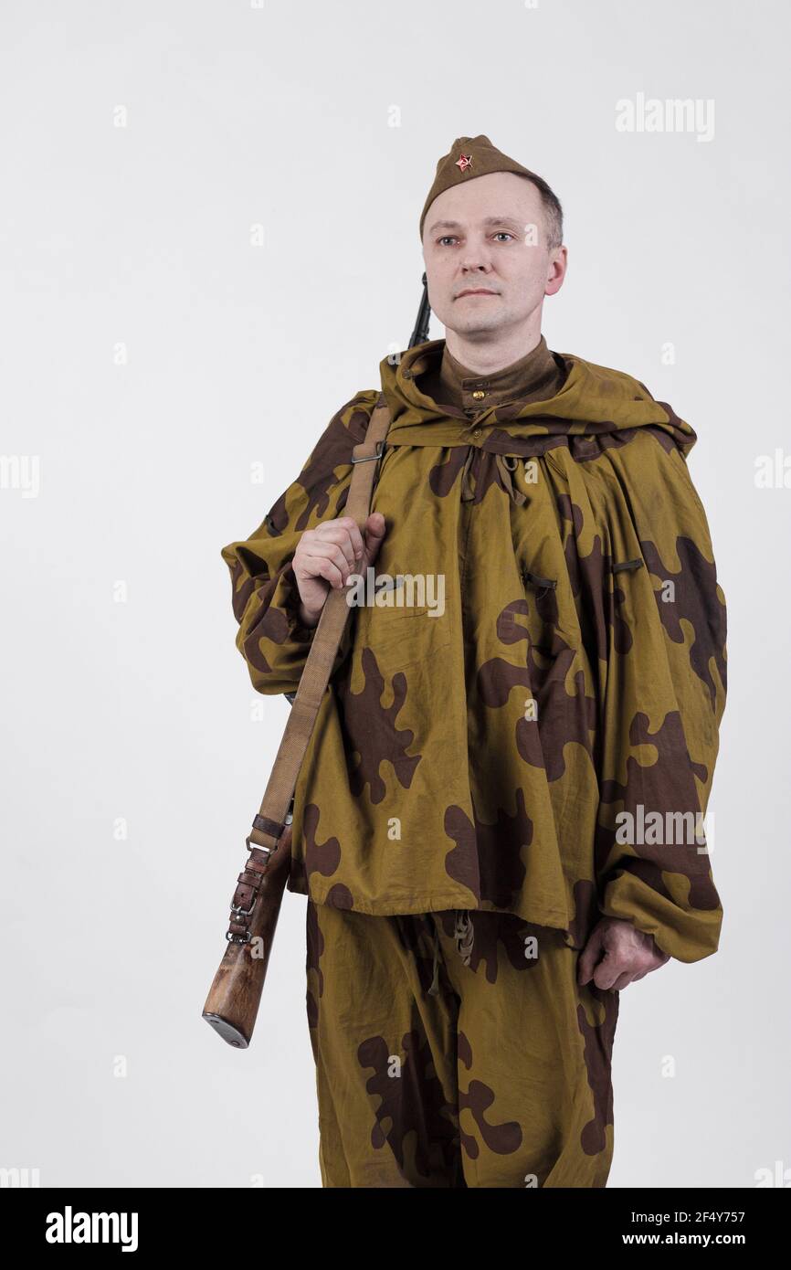 Actor man in an old military uniform and camouflage sniper marksman ...