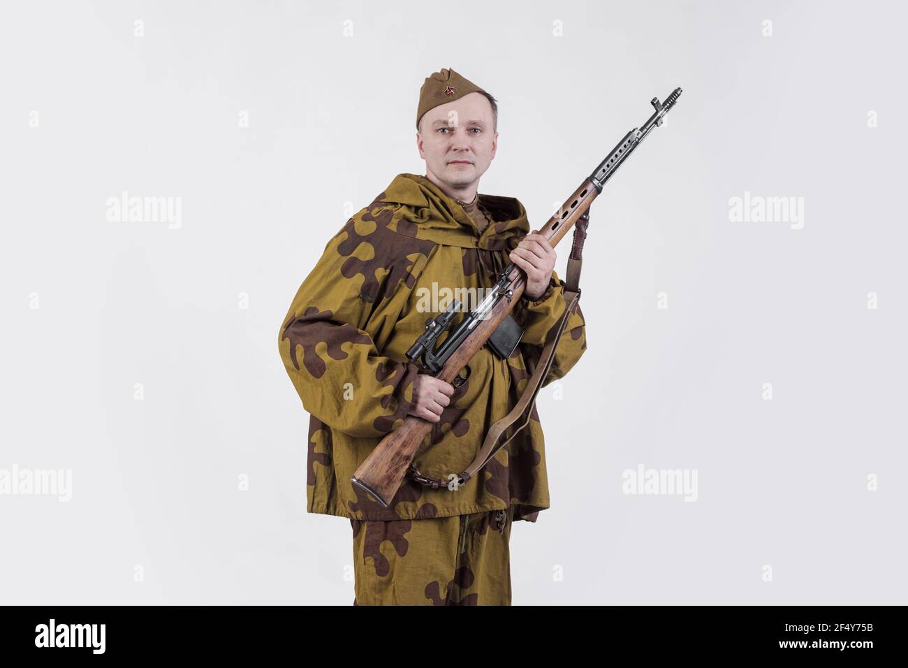 Actor man in an old military uniform and camouflage sniper marksman ...
