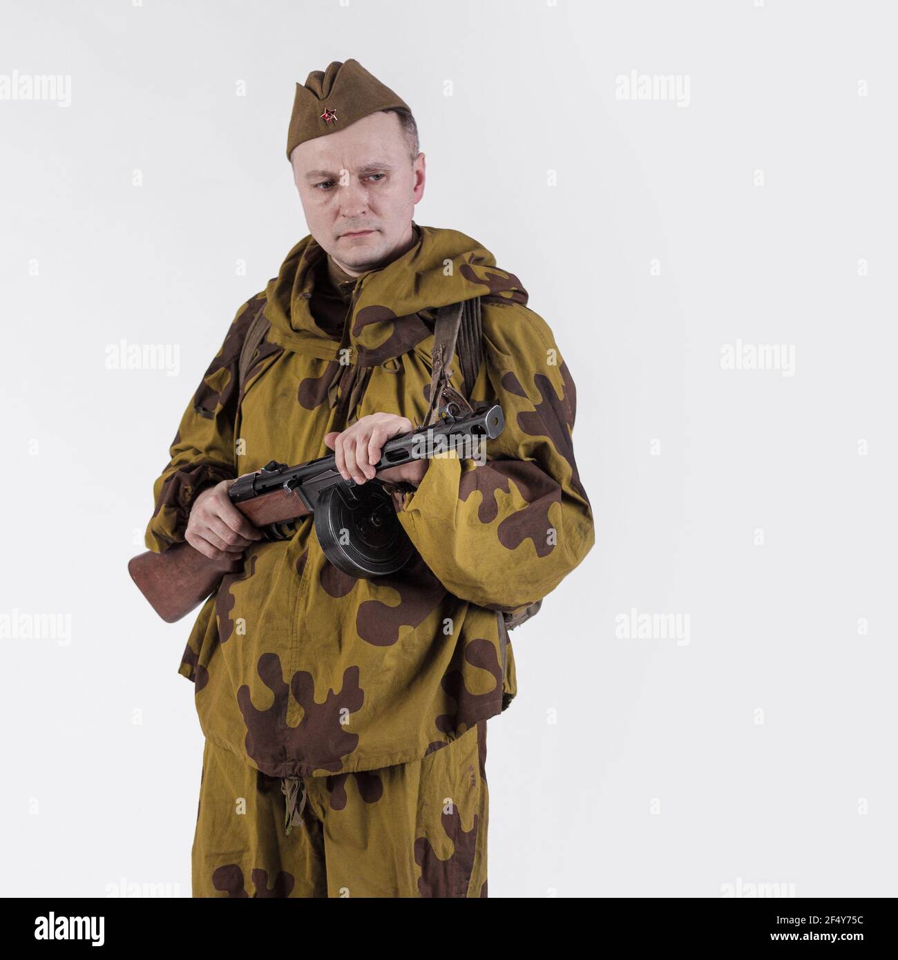 Actor man in an old military uniform and camouflage sniper marksman ...