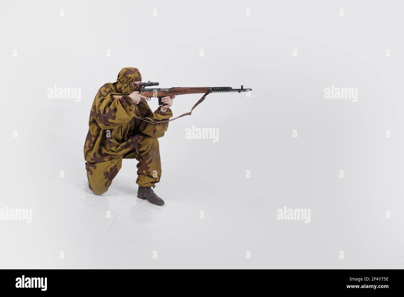 Actor man in an old military uniform and camouflage sniper marksman ...