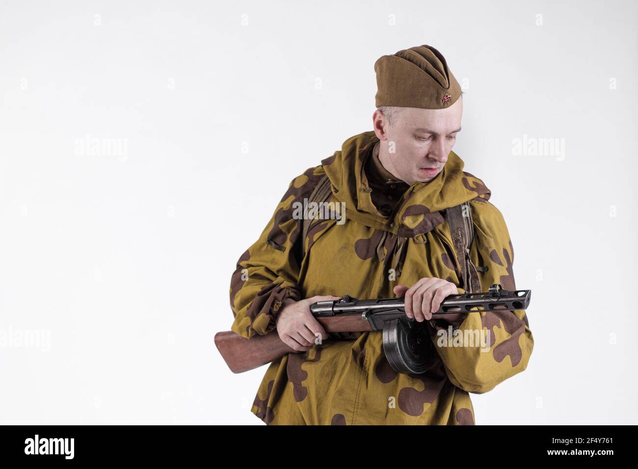 Actor man in an old military uniform and camouflage sniper marksman ...