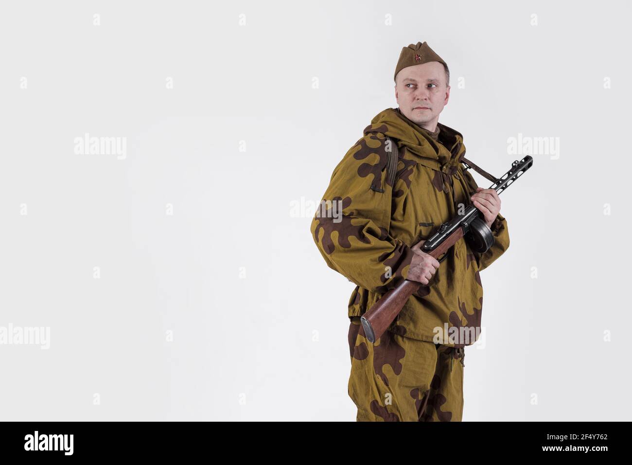 Actor man in an old military uniform and camouflage sniper marksman ...