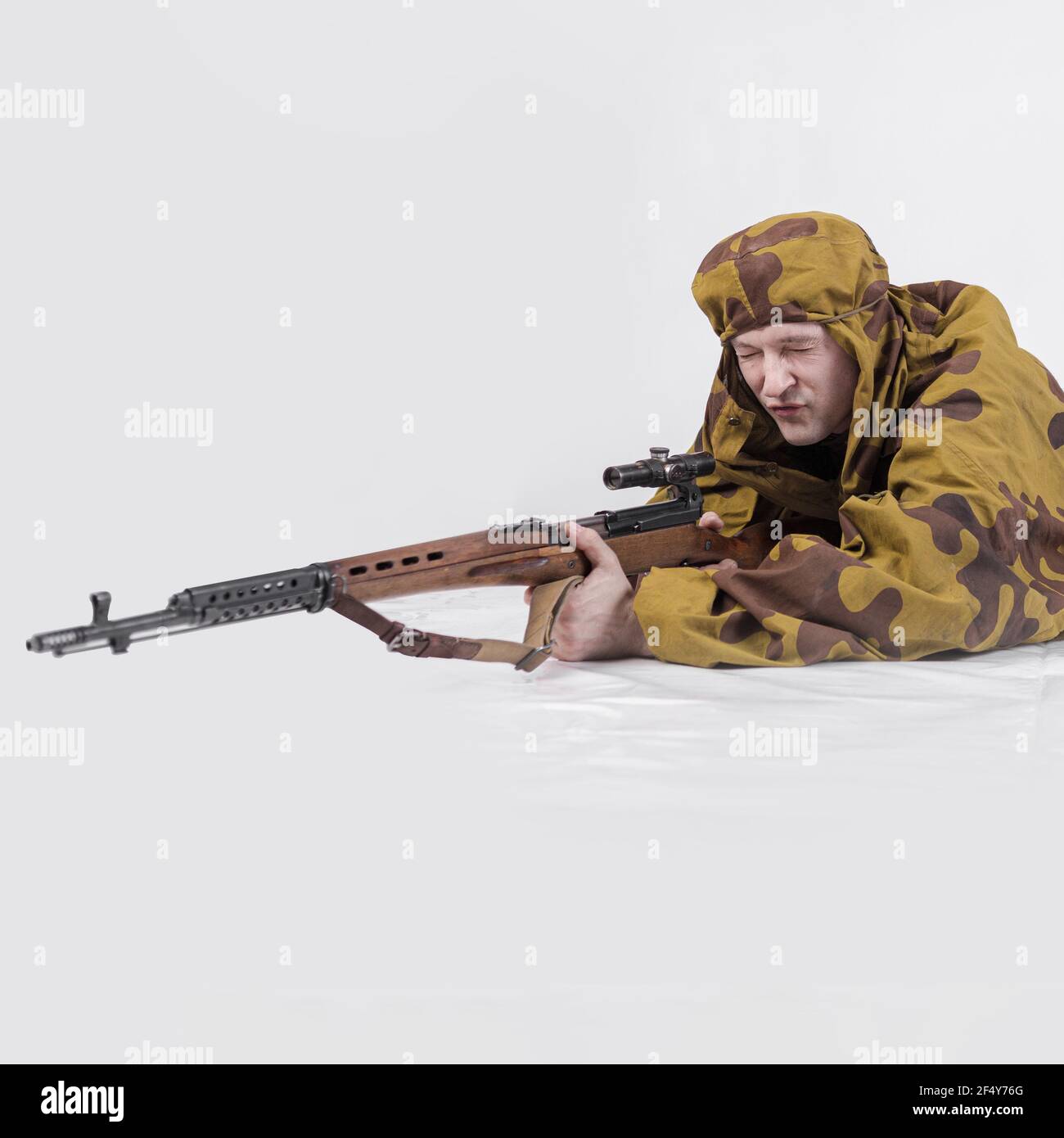 Actor man in an old military uniform and camouflage sniper marksman ...