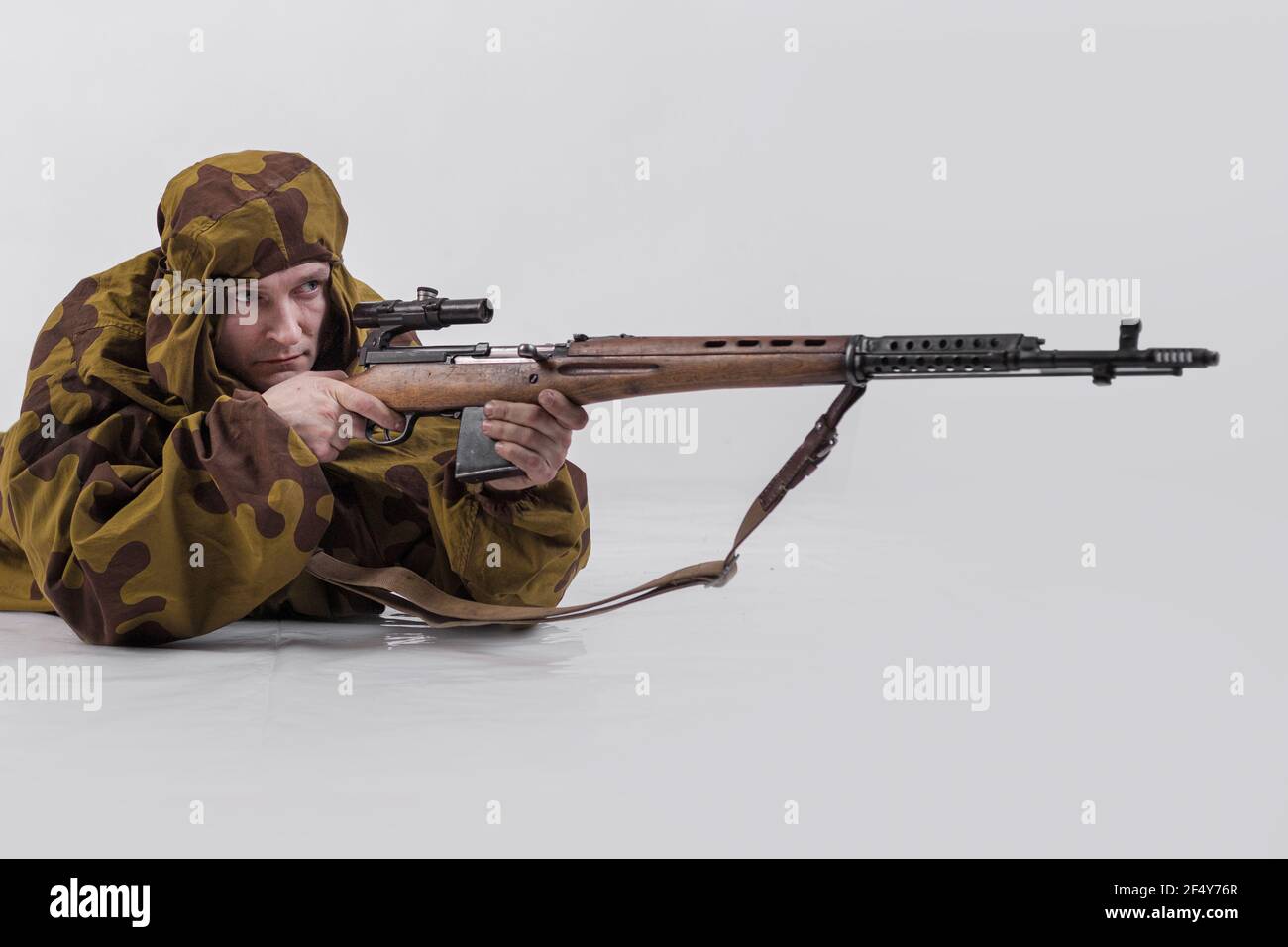 Actor man in an old military uniform and camouflage sniper marksman ...