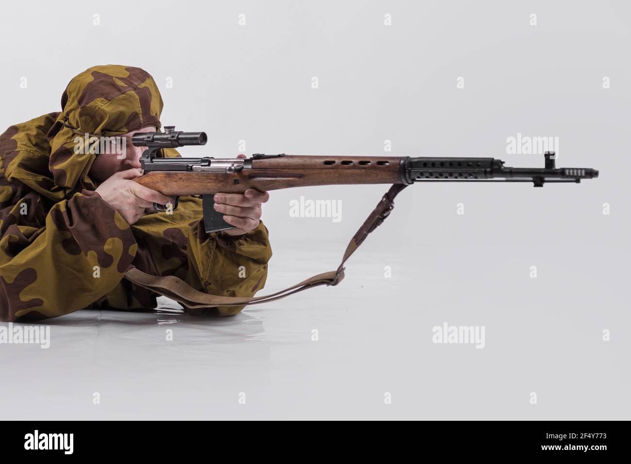 Actor man in an old military uniform and camouflage sniper marksman ...