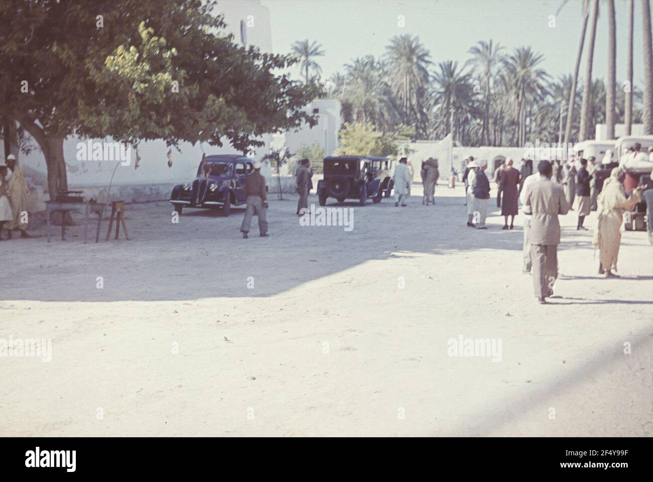 Travel photos. Libya. Ghadames. Streetscape with locals, cars and palm ...