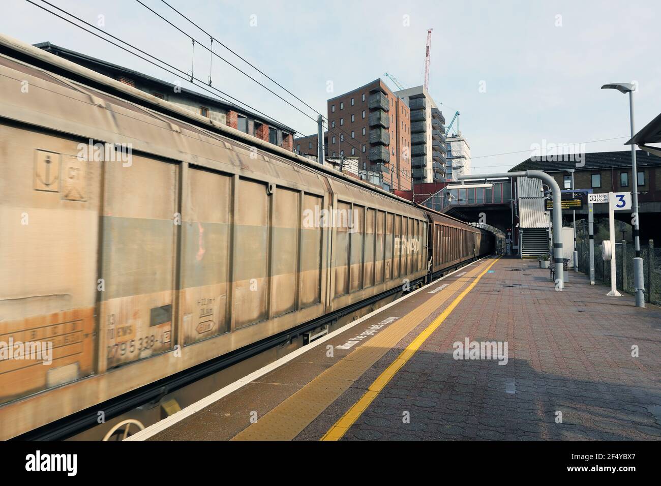 Freight train passing through west London station, UK Stock Photo - Alamy