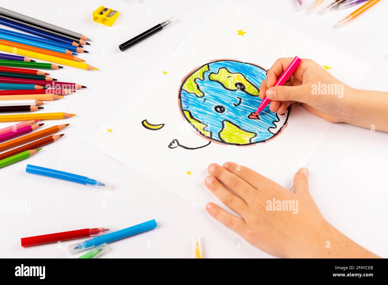 Child girl draws planet earth on a white sheet Stock Photo - Alamy