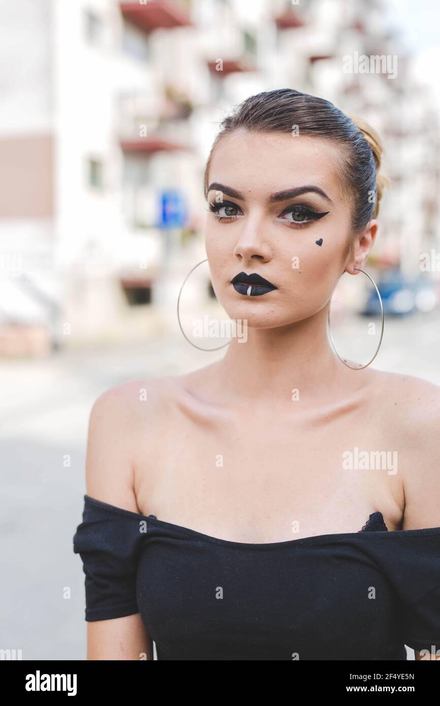 Attractive Bosnian Caucasian woman wearing a black shirt looking at the ...