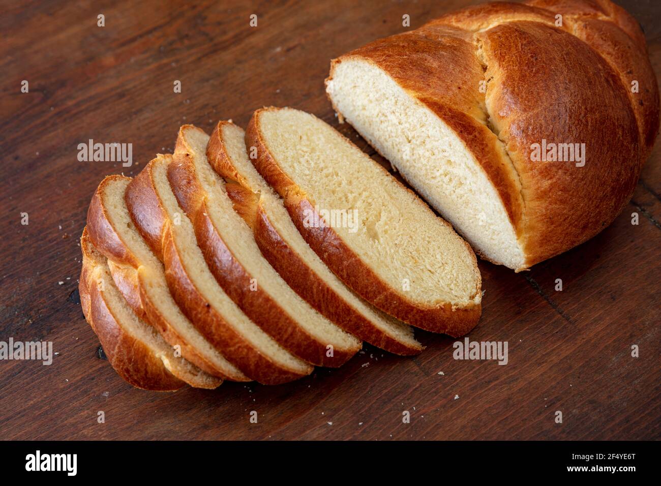Easter sweet bread, tsoureki cozonac loaf slices on wooden table ...