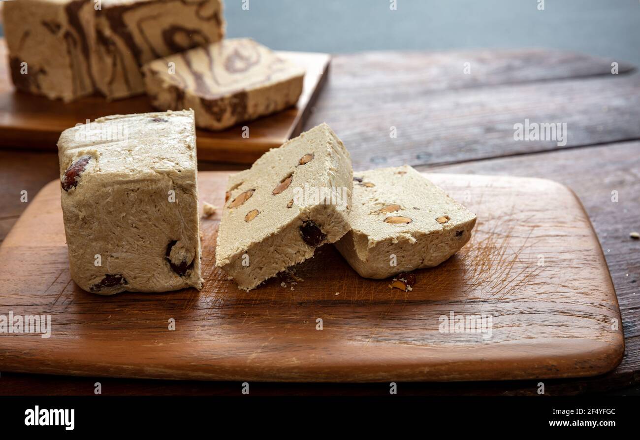 Halva almonds and cocoa on wooden table background. Vanilla halvah or ...